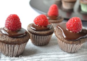 Two bite Mini Chocolate Raspberry Cupcakes with fresh raspberries